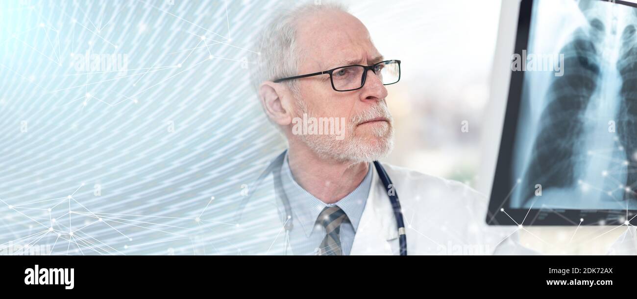 Senior doctor looking at x-ray in clinic; panoramic banner Stock Photo ...