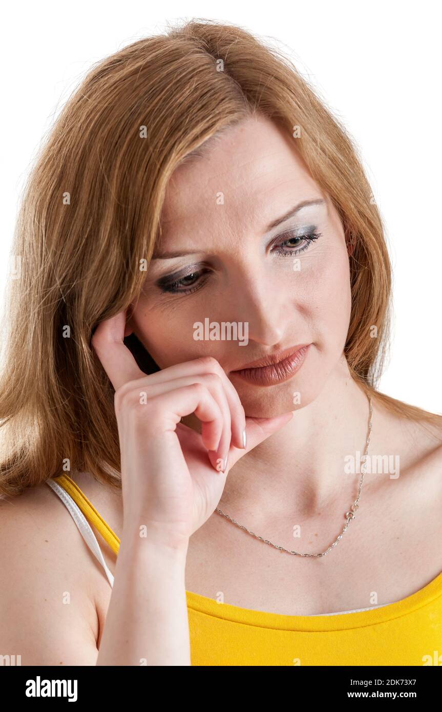Head and shoulder portrait of a withdrawn young woman with bowed eyes ...