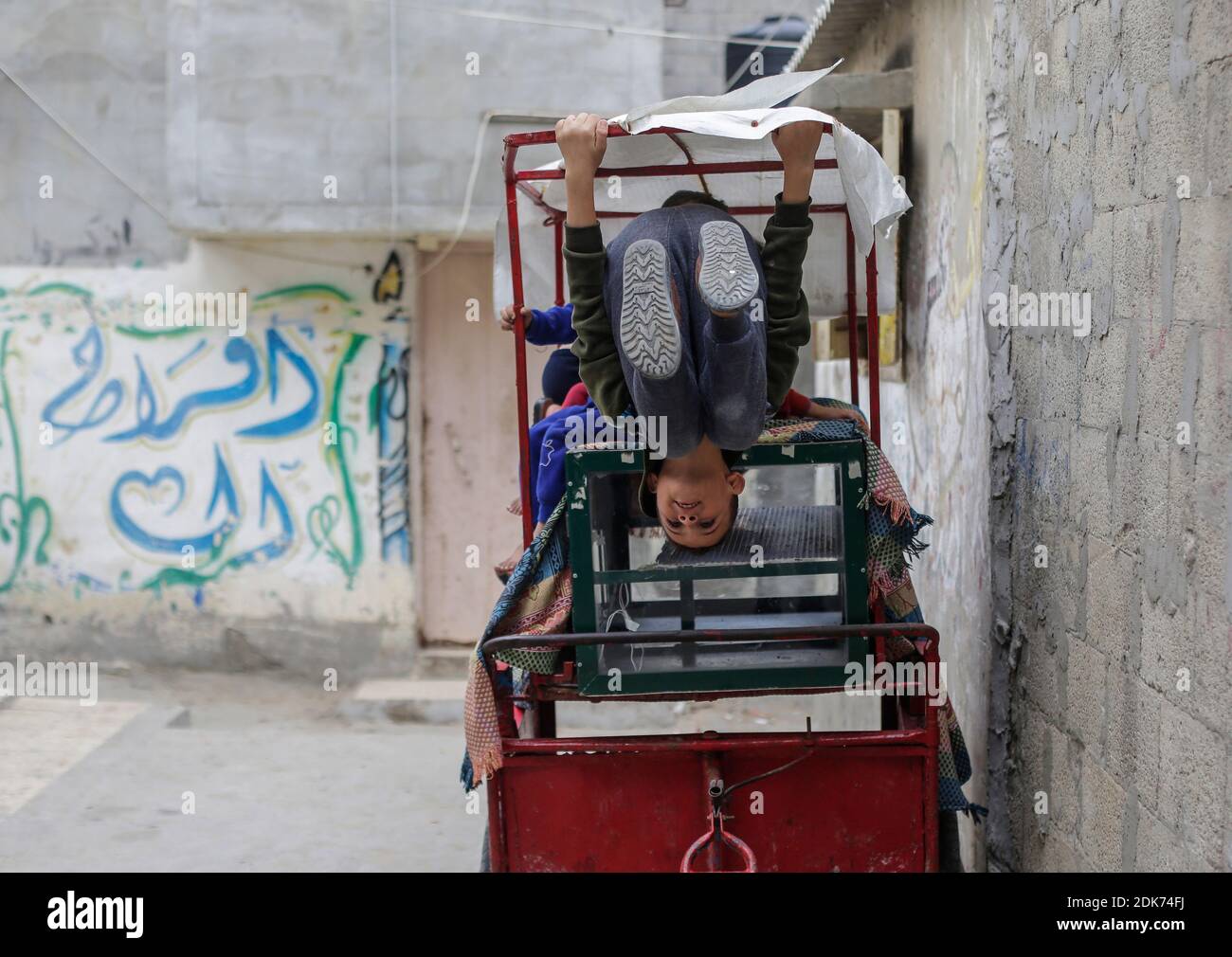 Gaza, Palestine. 14th Dec, 2020. Palestinian children play outside ...