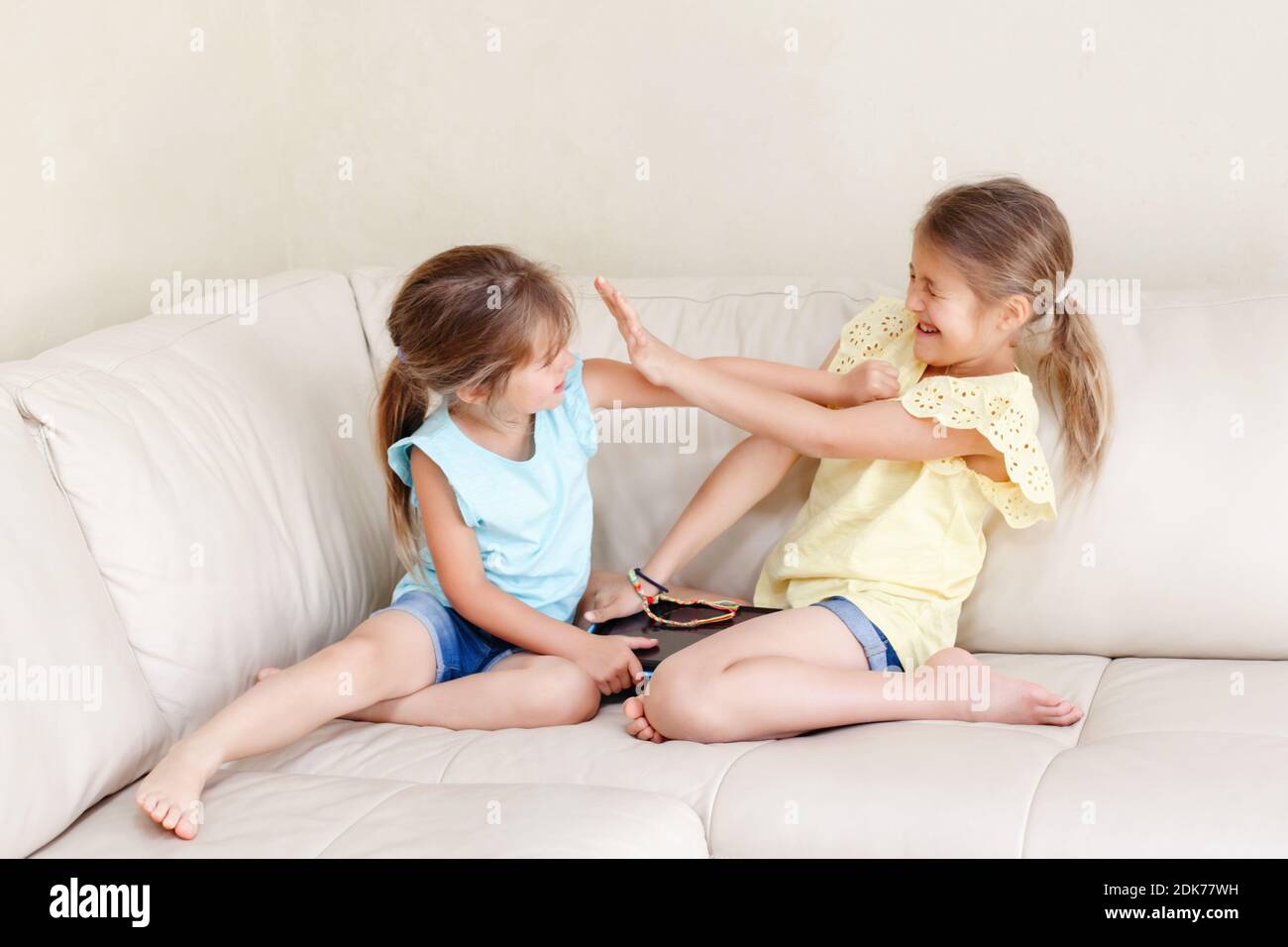 Girls fighting on sofa hi-res stock photography and images - Alamy