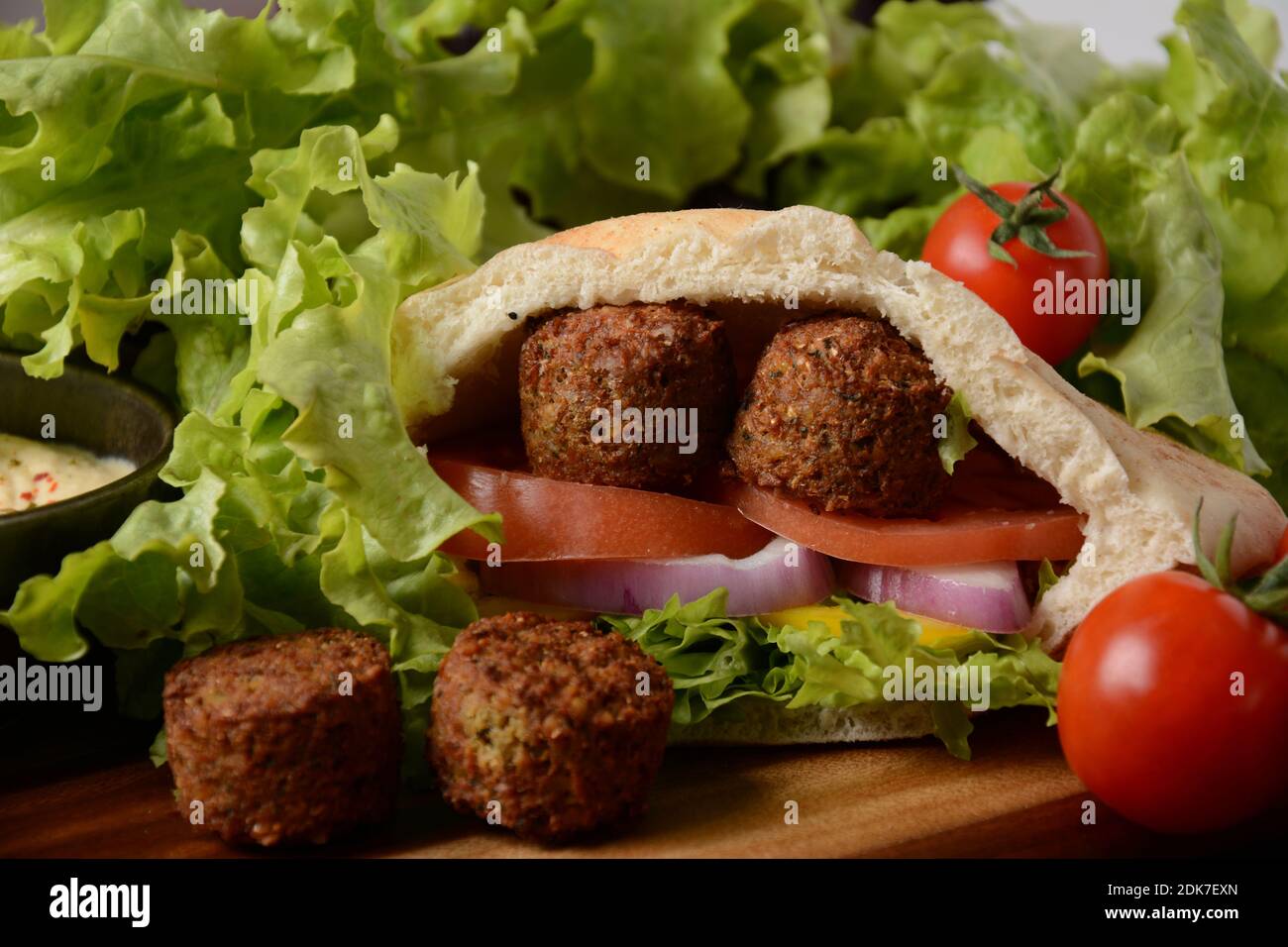 Falafel in pita bread with vegetable salad, harissa sauce, humus ...