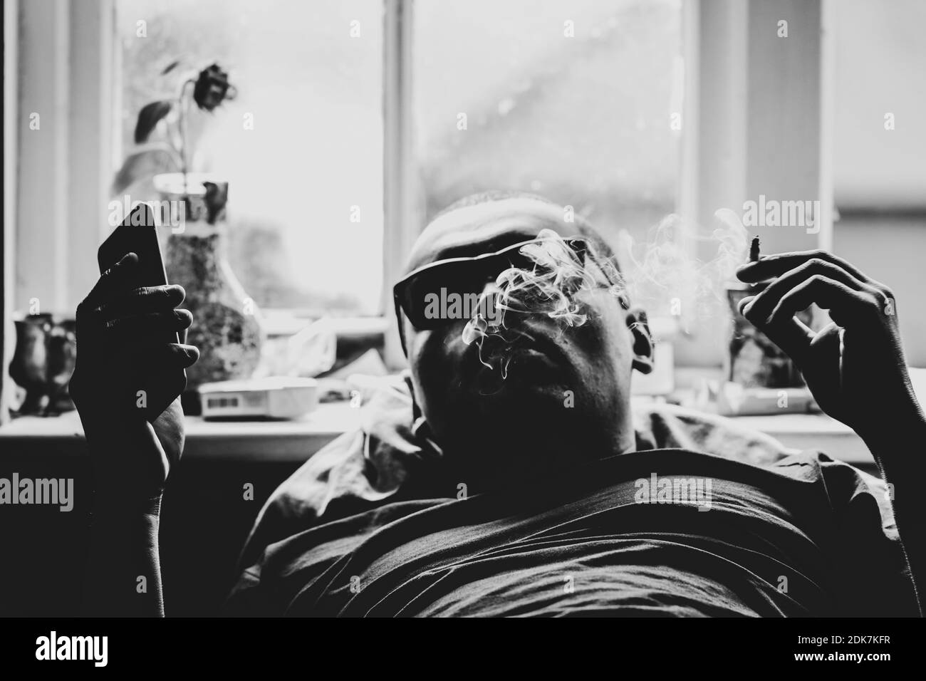 Mobile phone smoking cigarette Black and White Stock Photos & Images ...