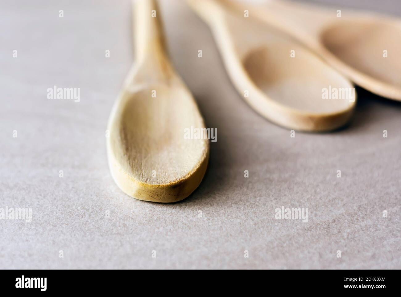 Group of wooden kitchen spoons arranged on a gray marble table. Kitchen ...