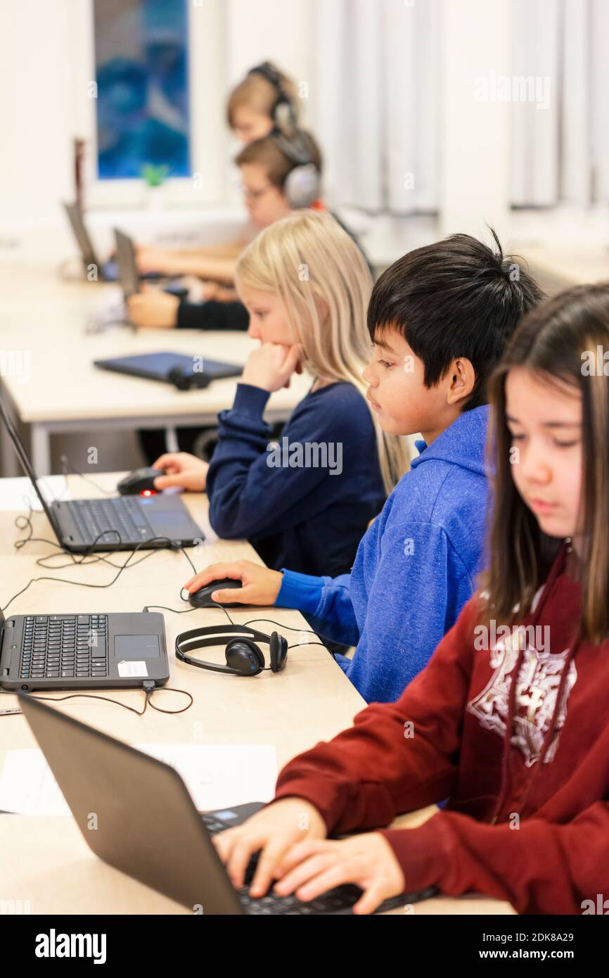 Children in classroom using laptops Stock Photo - Alamy