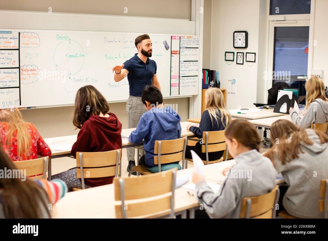Teacher in front of class Stock Photo - Alamy