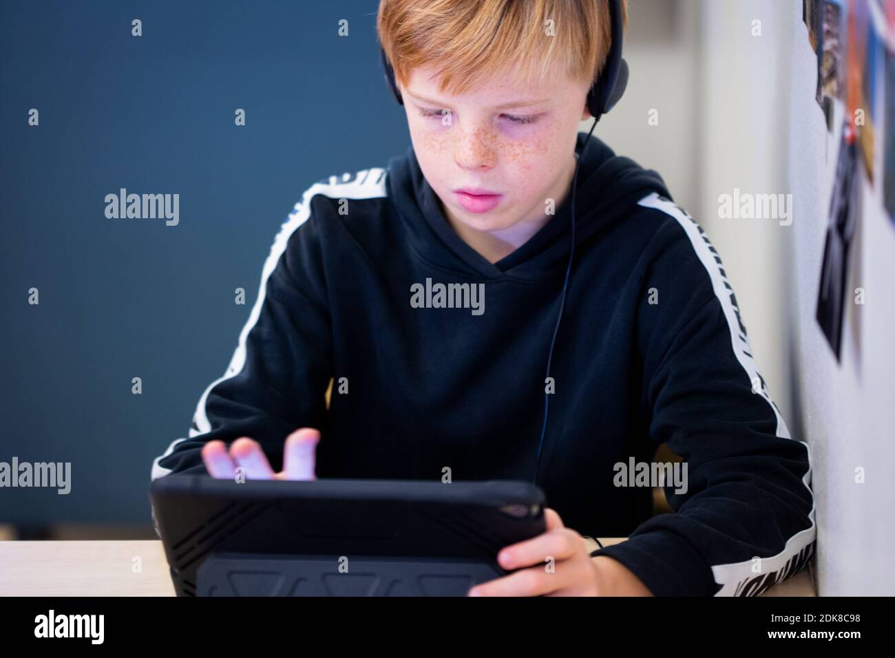 Boy using digital tablet in classroom Stock Photo - Alamy