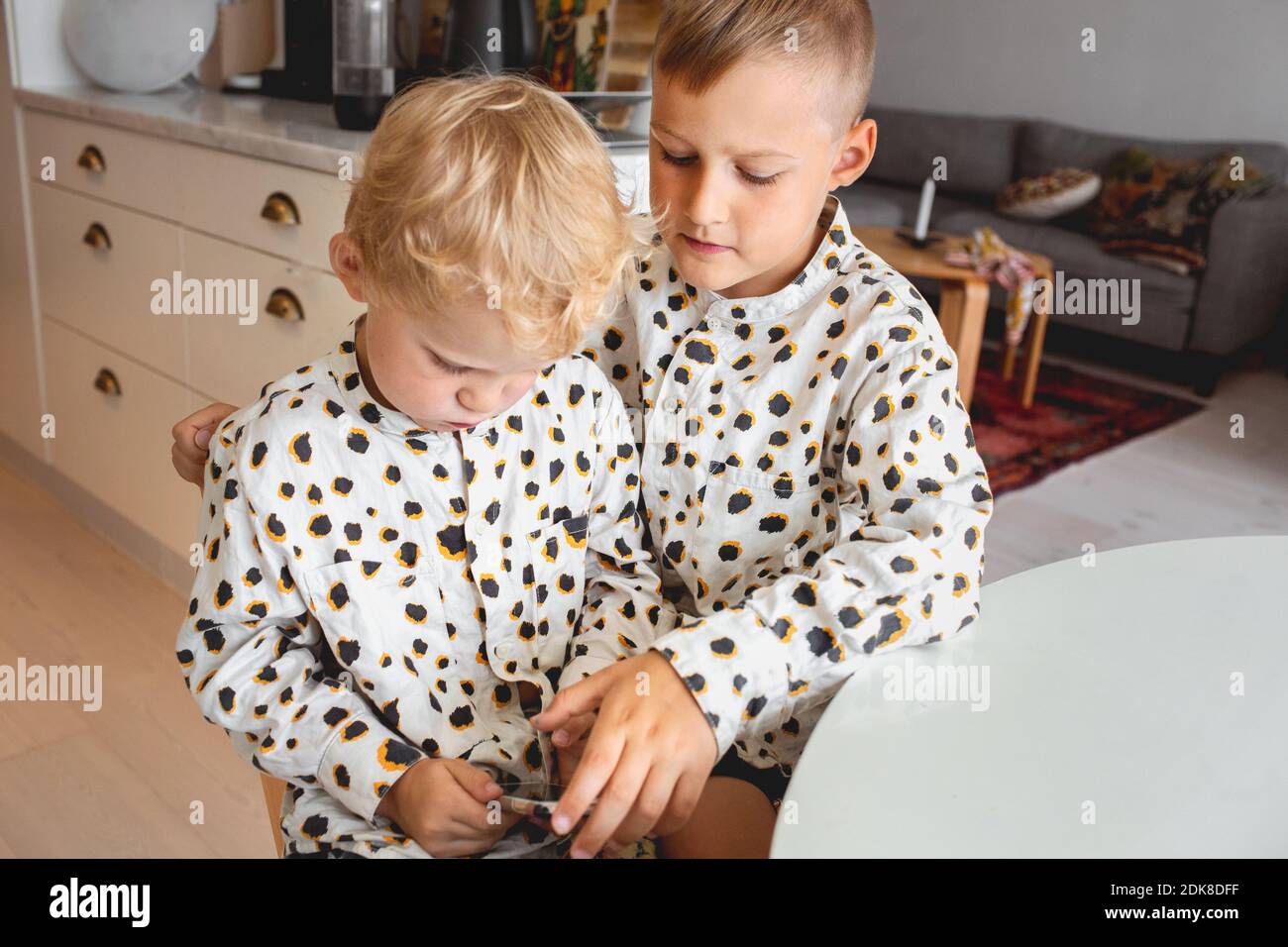 Brothers sitting together Stock Photo - Alamy