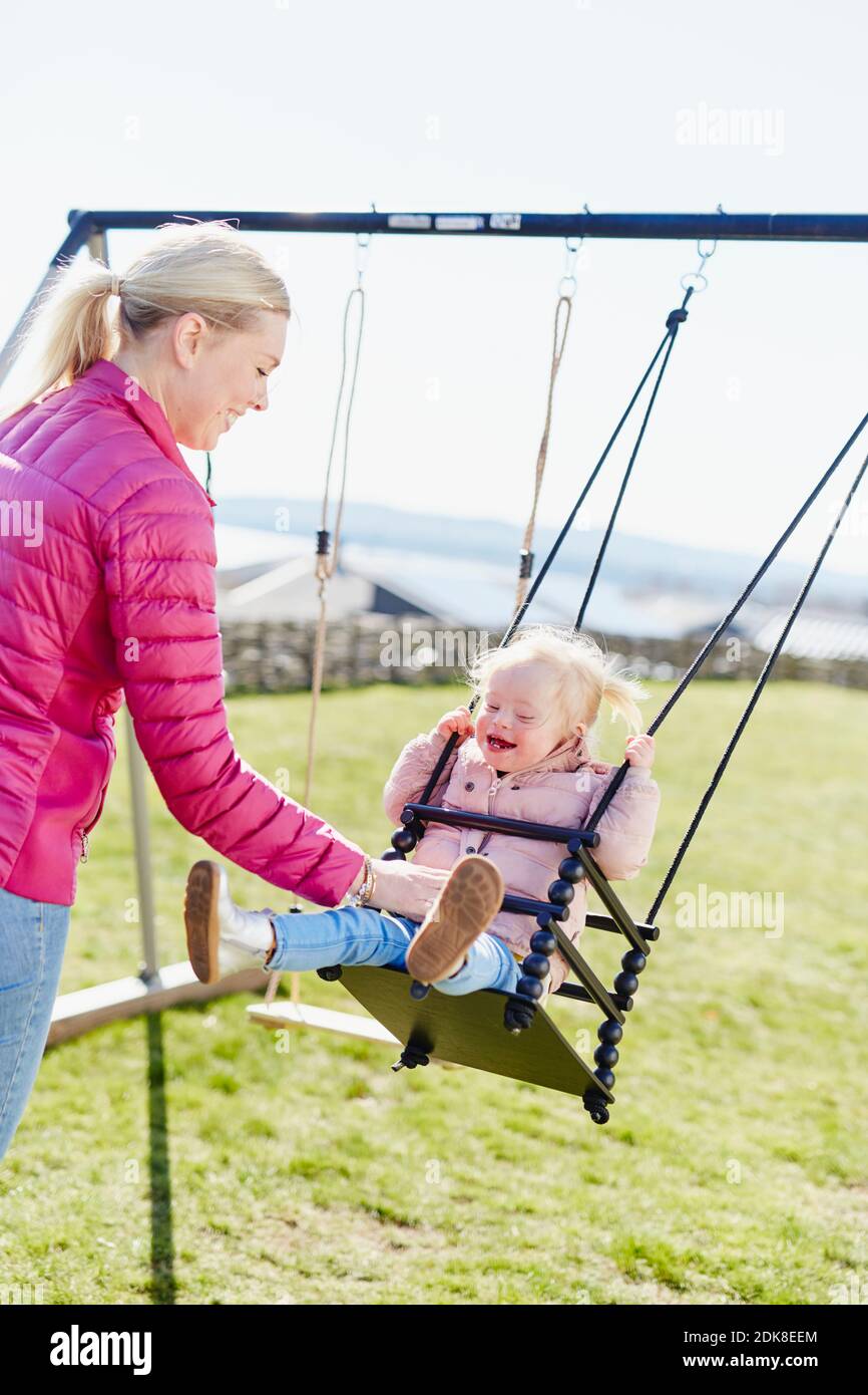 Mother swinging daughter hi-res stock photography and images - Alamy