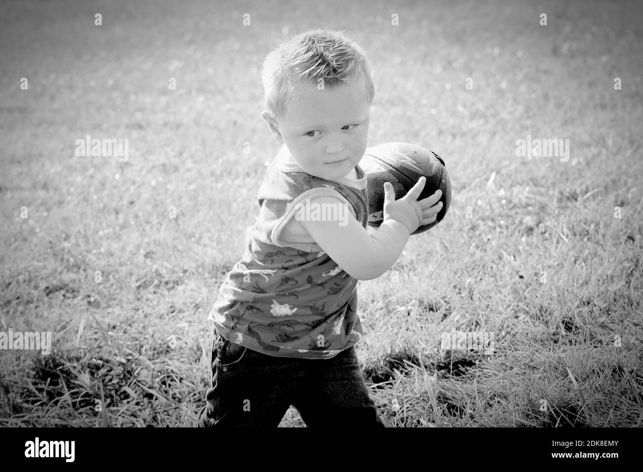 Boys playing football Black and White Stock Photos & Images - Alamy