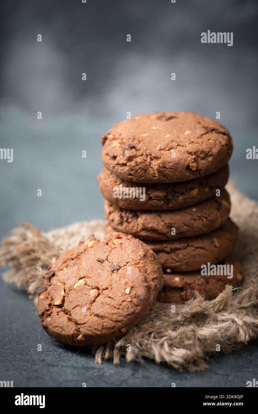 Cookies with hazelnuts and chocolate, dark moody sweets, empty copy ...