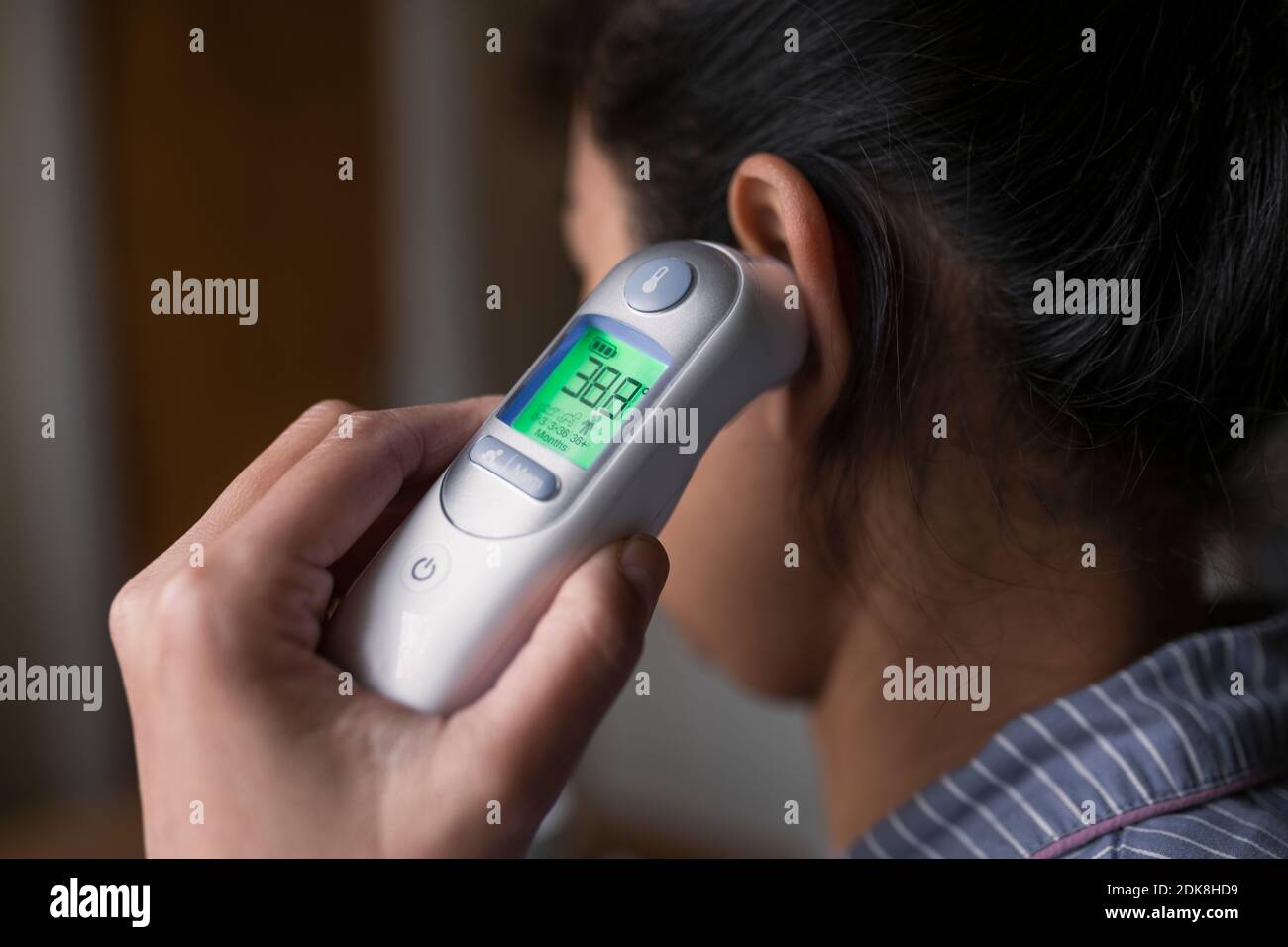 Woman checking her temperature Stock Photo - Alamy