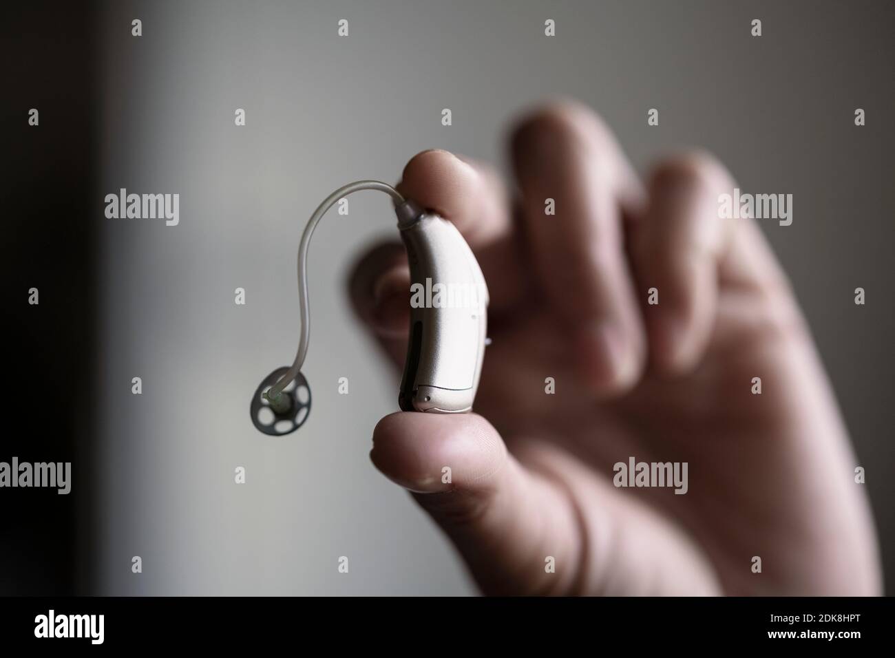 Hand holding hearing aid Stock Photo - Alamy