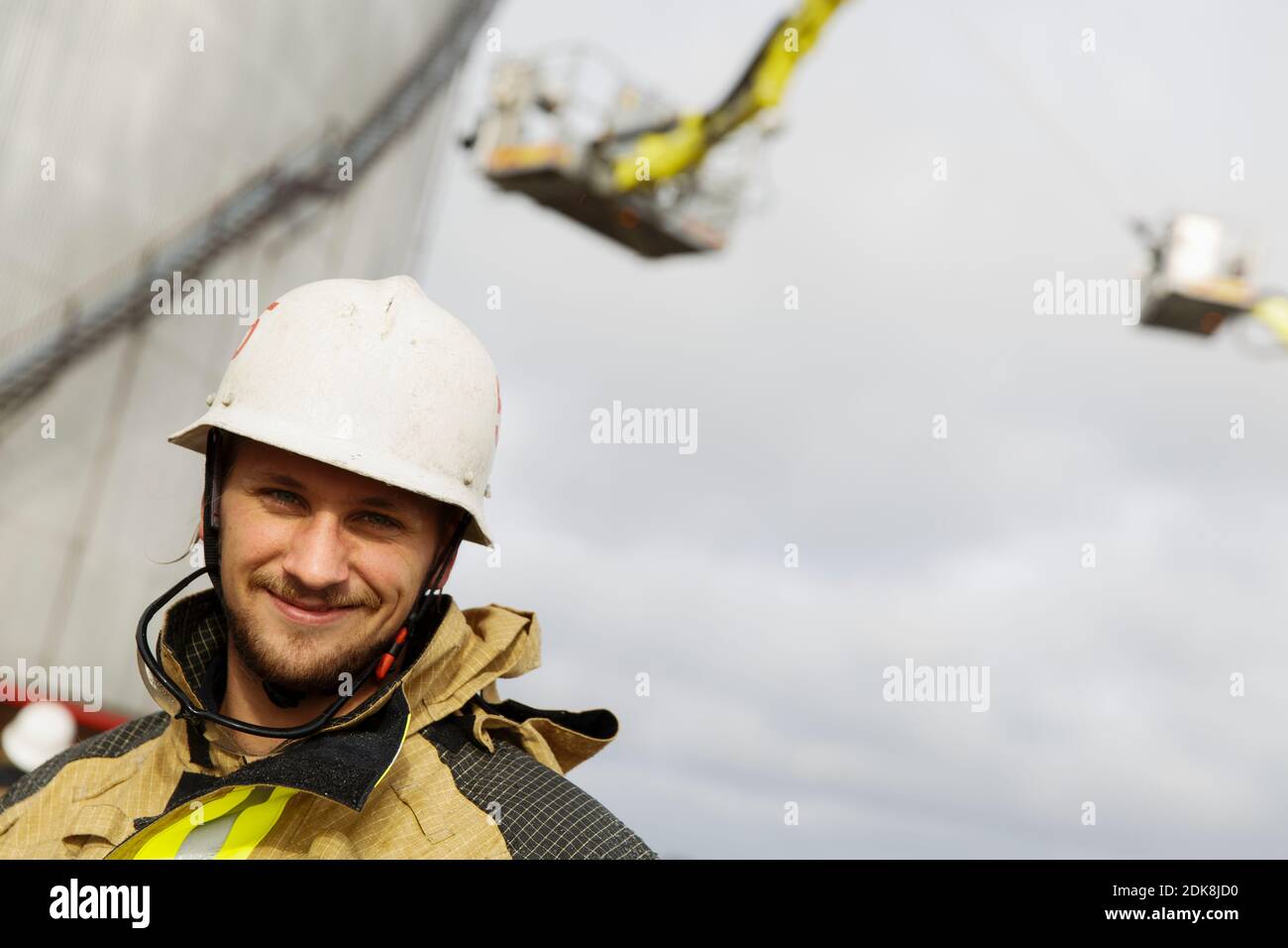 Portrait of young fire-fighter Stock Photo - Alamy