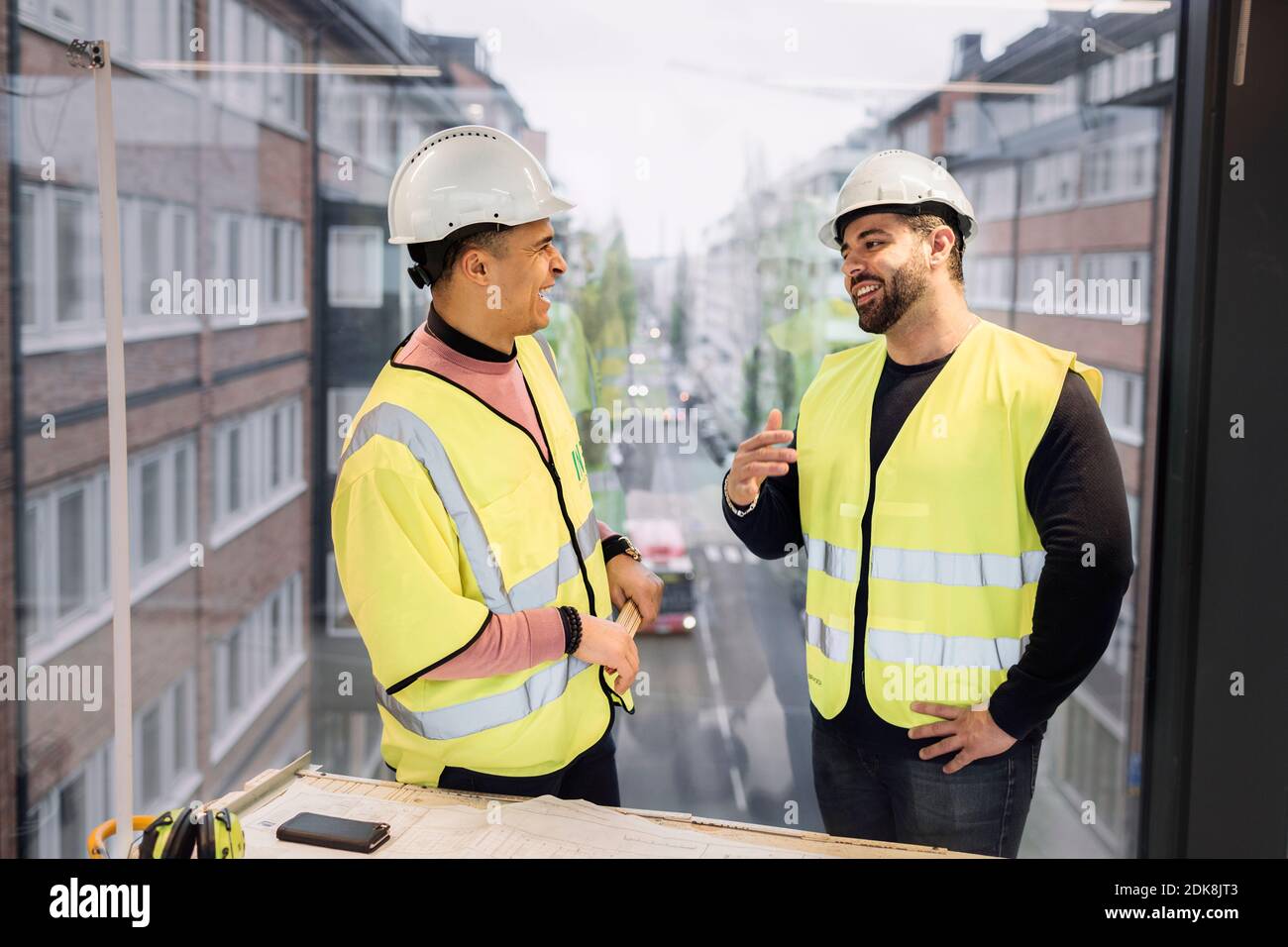 Workers talking at construction site Stock Photo - Alamy