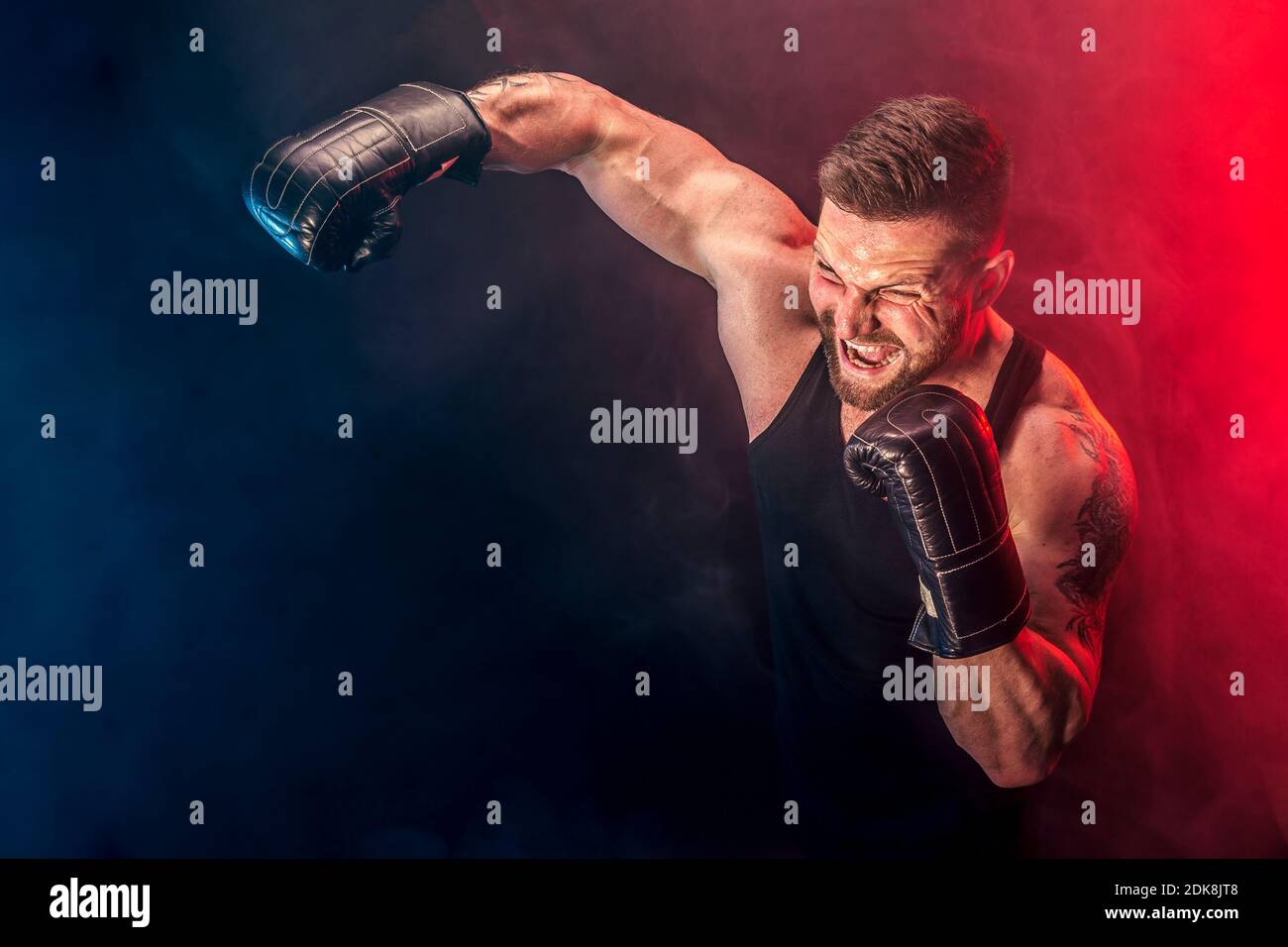 Bearded tattooed sportsman muay thai boxer in black undershirt and ...