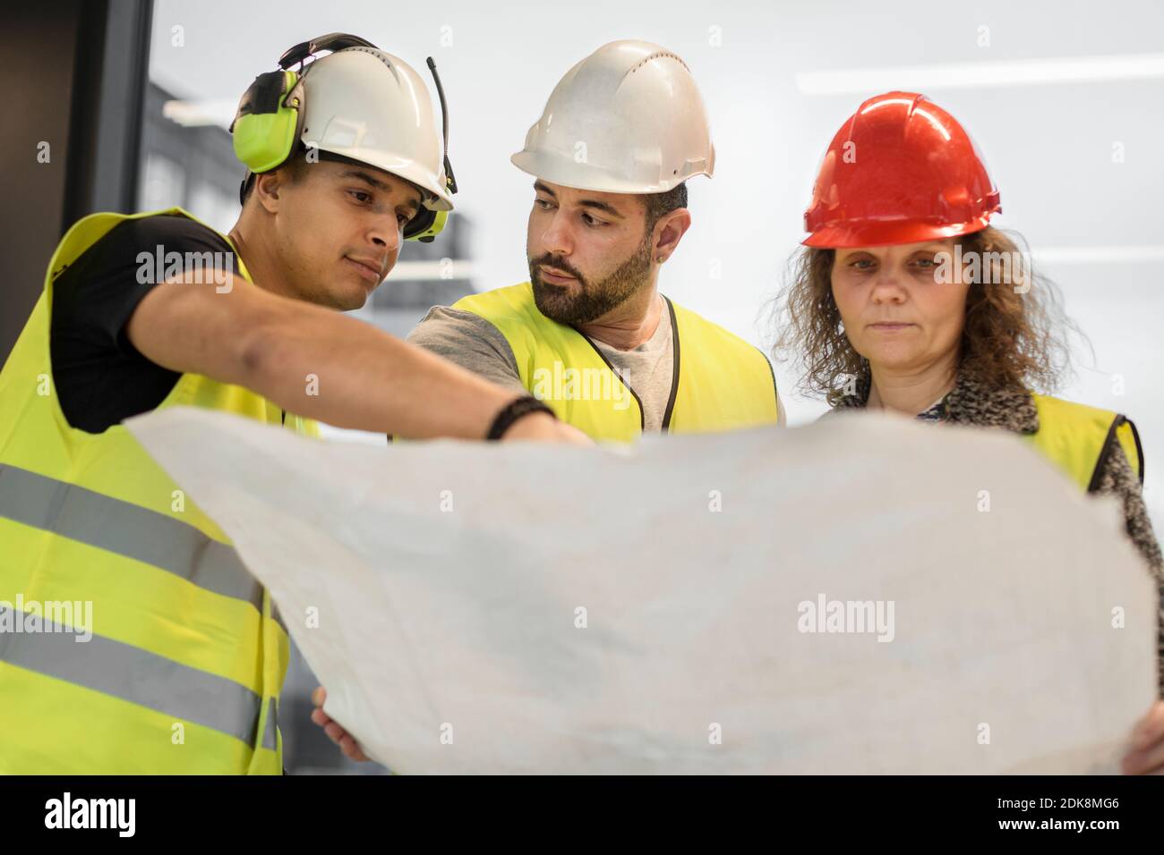 Workers reviewing blueprint at construction site Stock Photo - Alamy Workers reviewing blueprint at construction site Stock Photo - Alamy