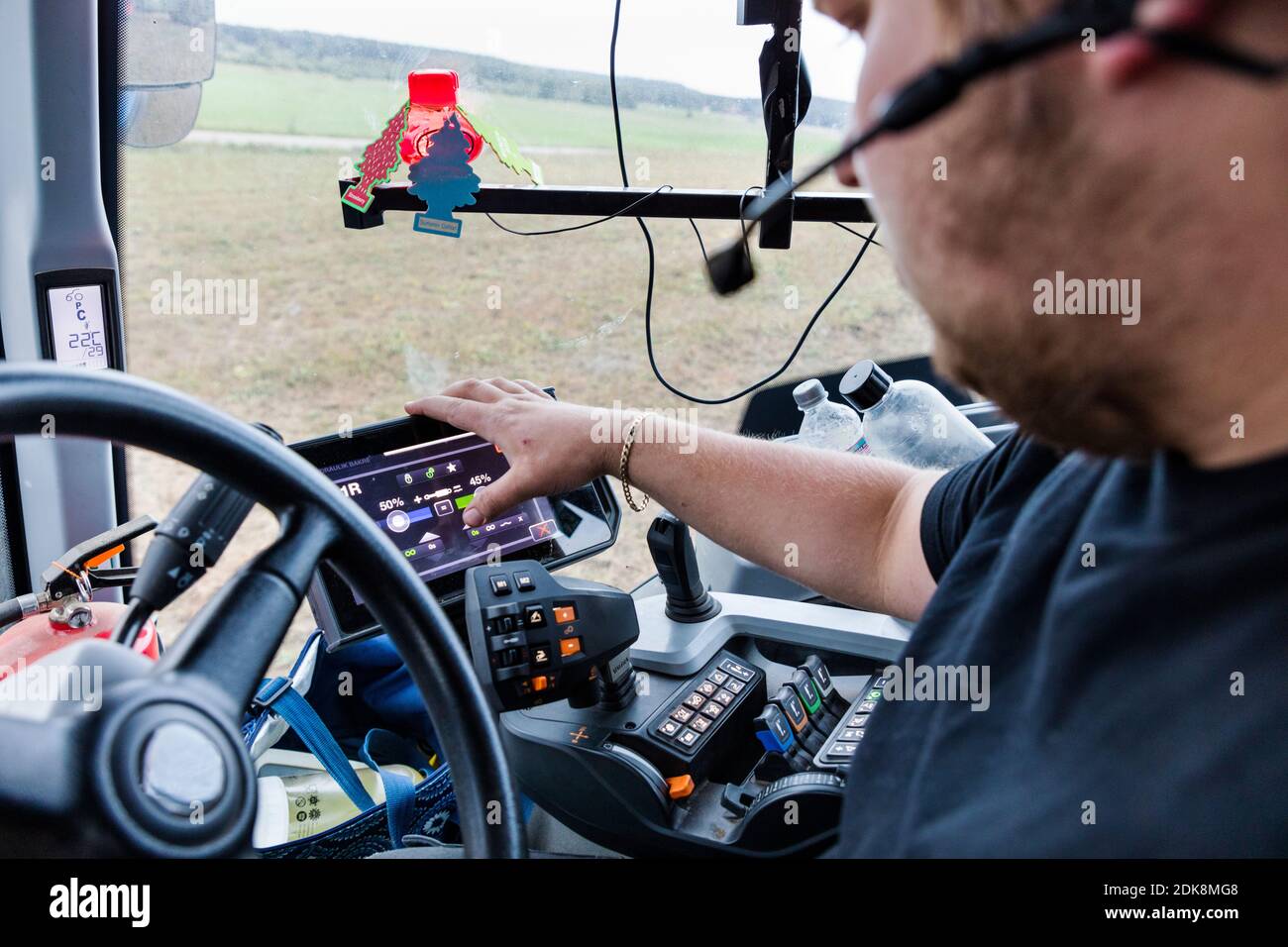 Driver in machine cabin Stock Photo - Alamy