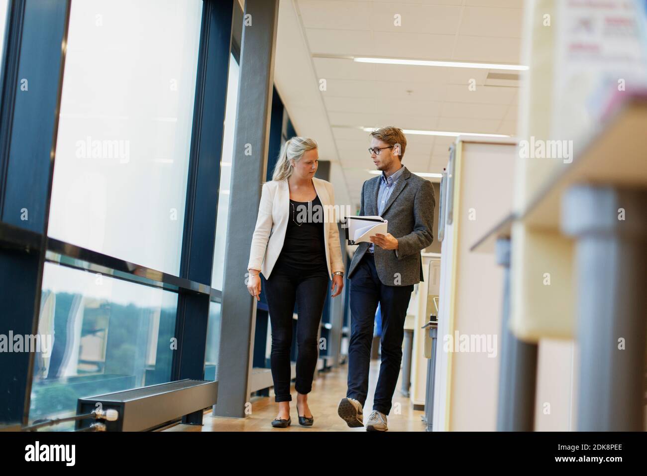 Business people walking through corridor Stock Photo - Alamy