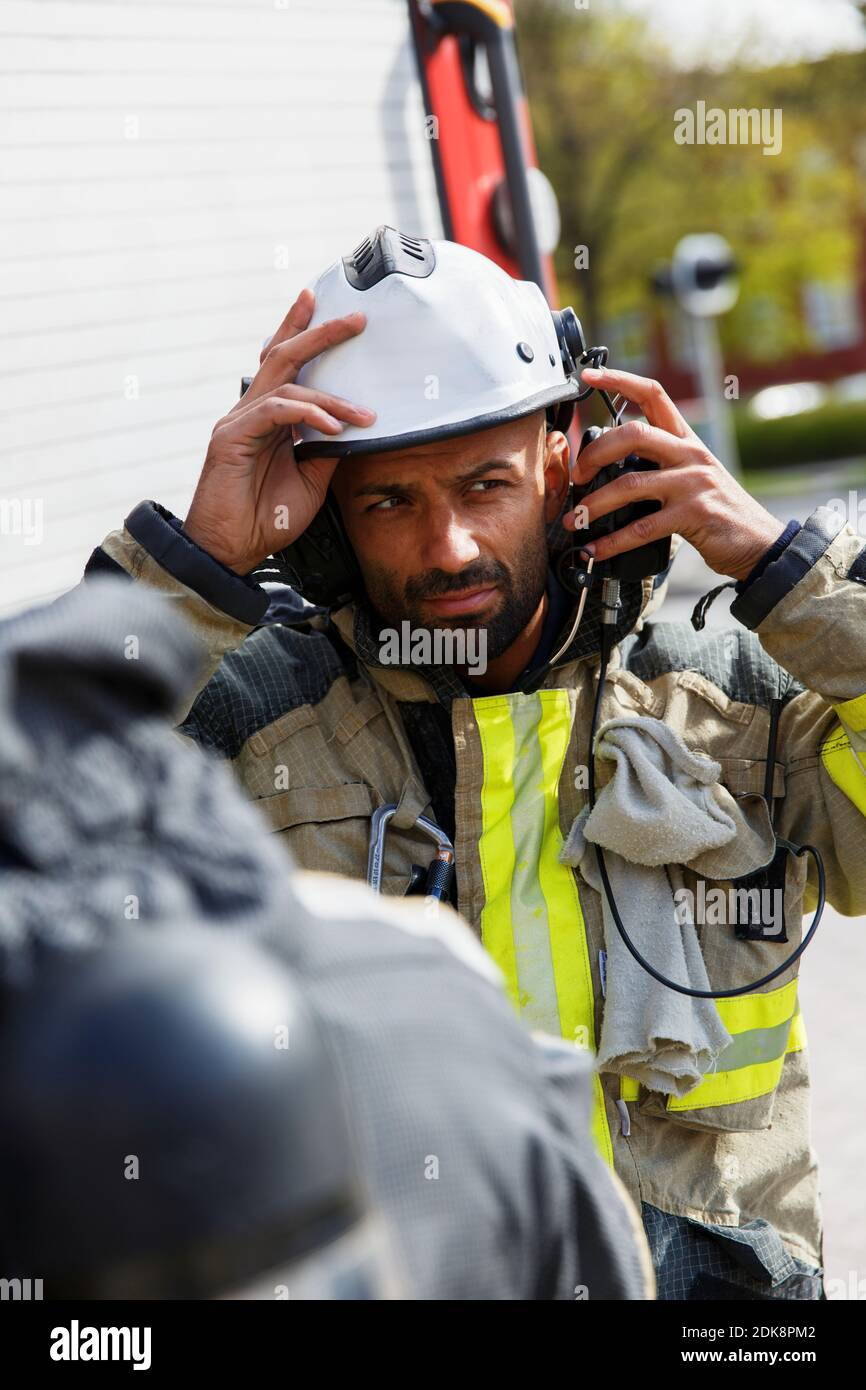 Firefighter looking away Stock Photo - Alamy