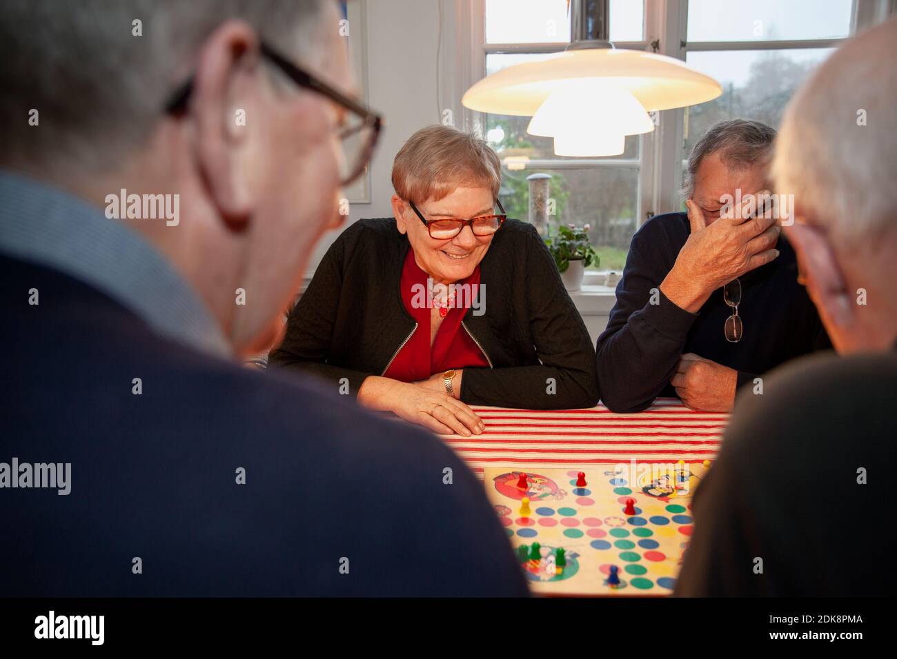 Senior people playing board game Stock Photo - Alamy