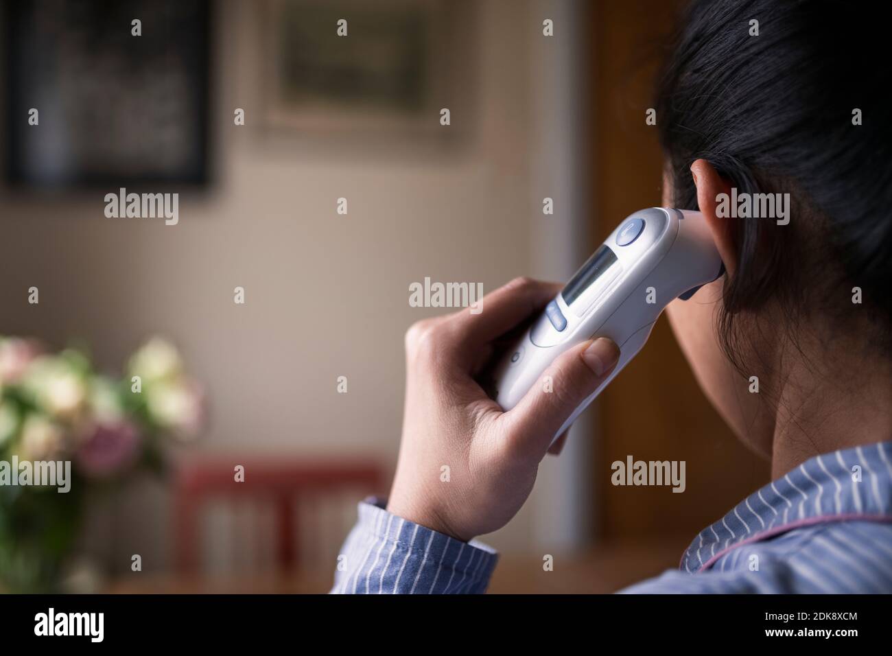 Woman checking her temperature Stock Photo - Alamy