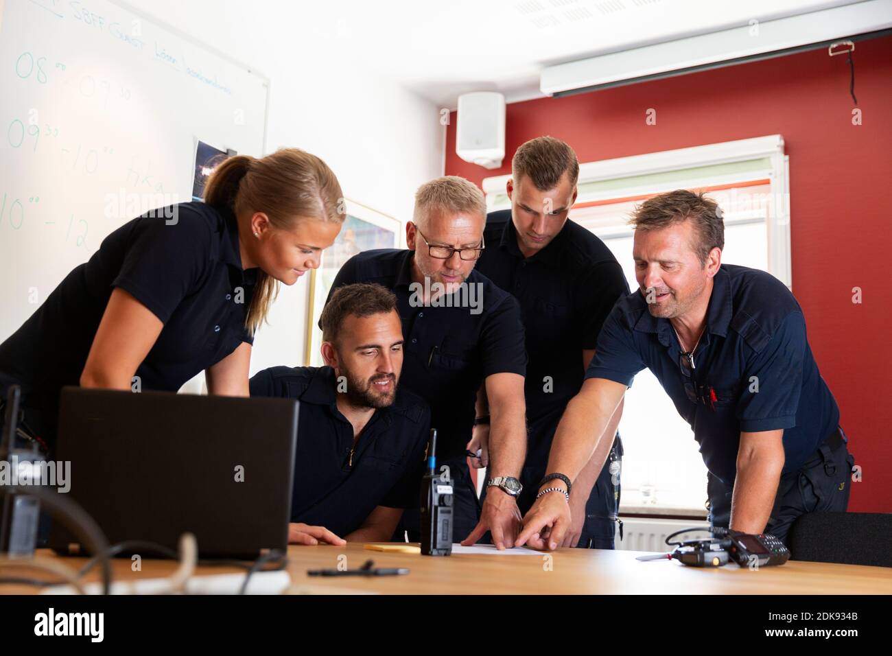 Firefighters talking in office Stock Photo - Alamy