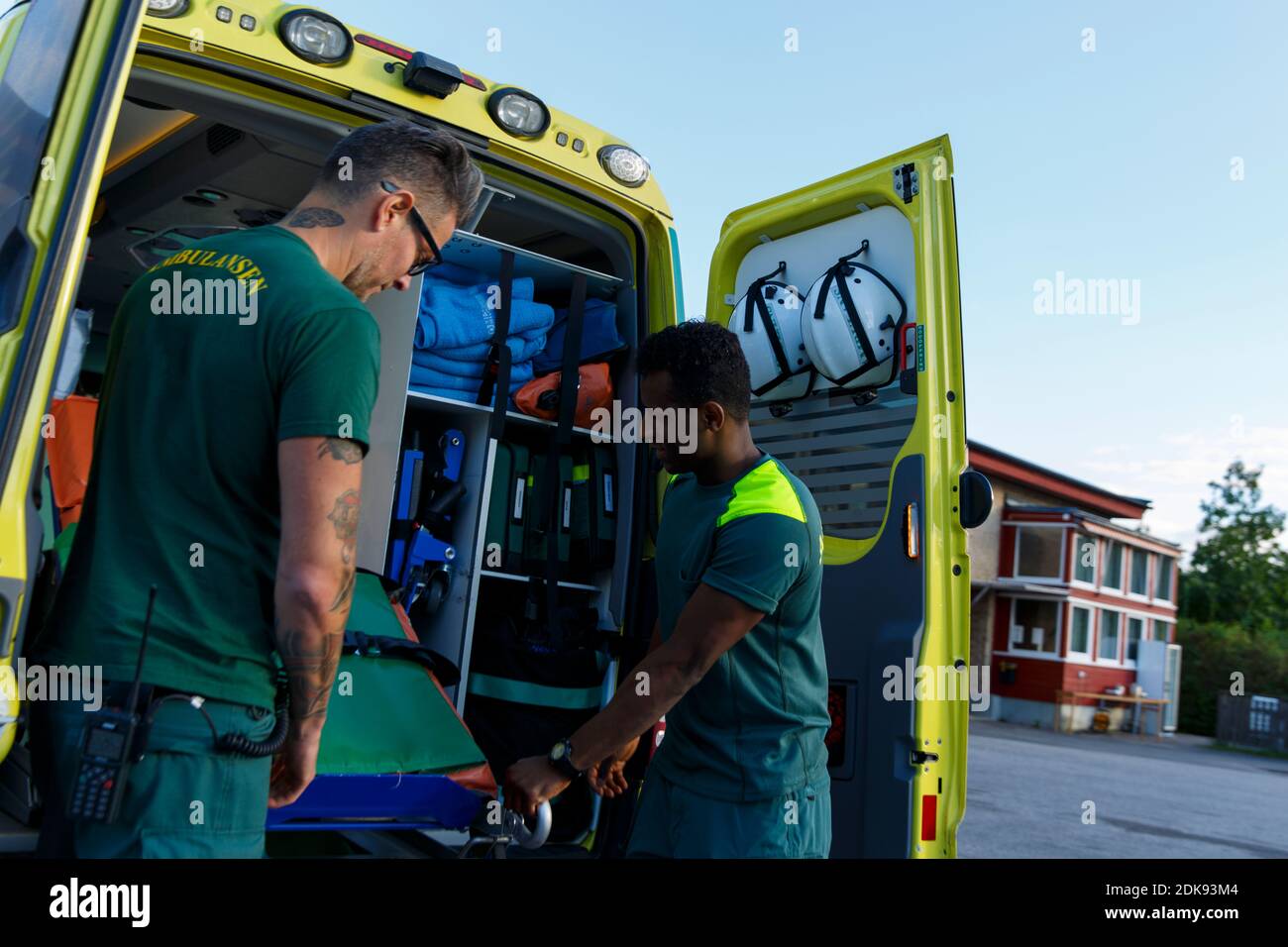 Paramedics standing next to ambulance Stock Photo - Alamy