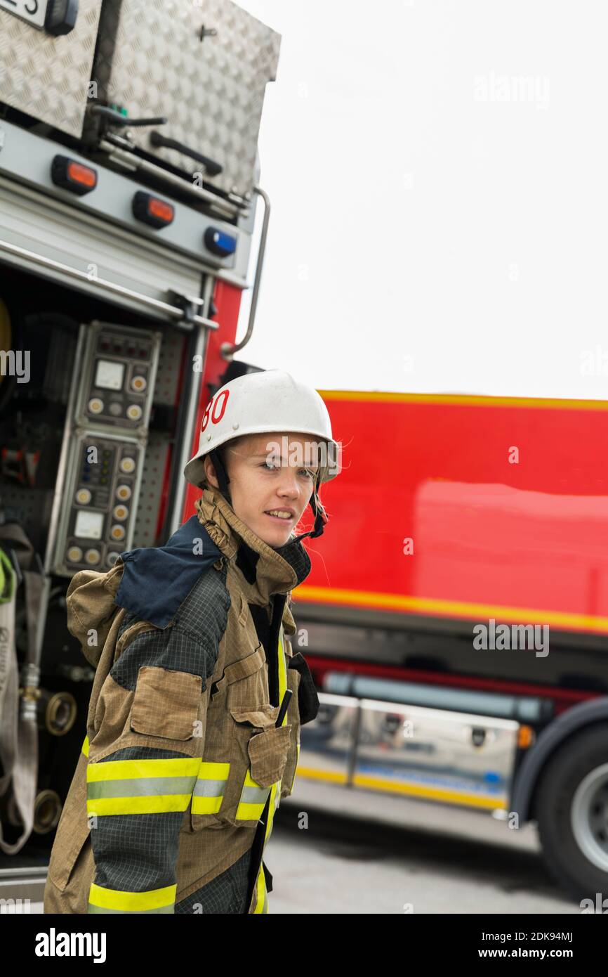 Female firefighter by fire engine Stock Photo - Alamy