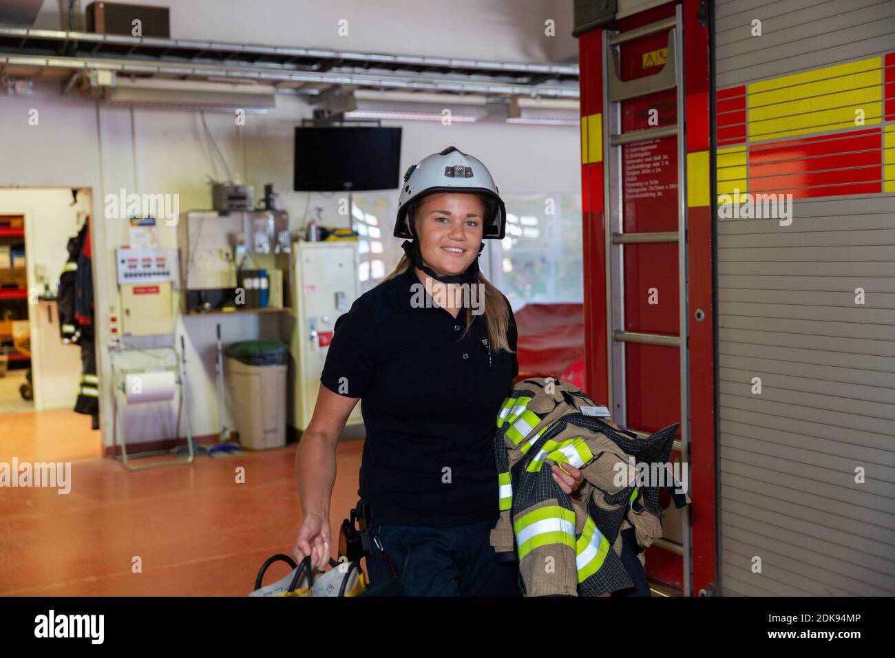 Female firefighter in fire station Stock Photo - Alamy