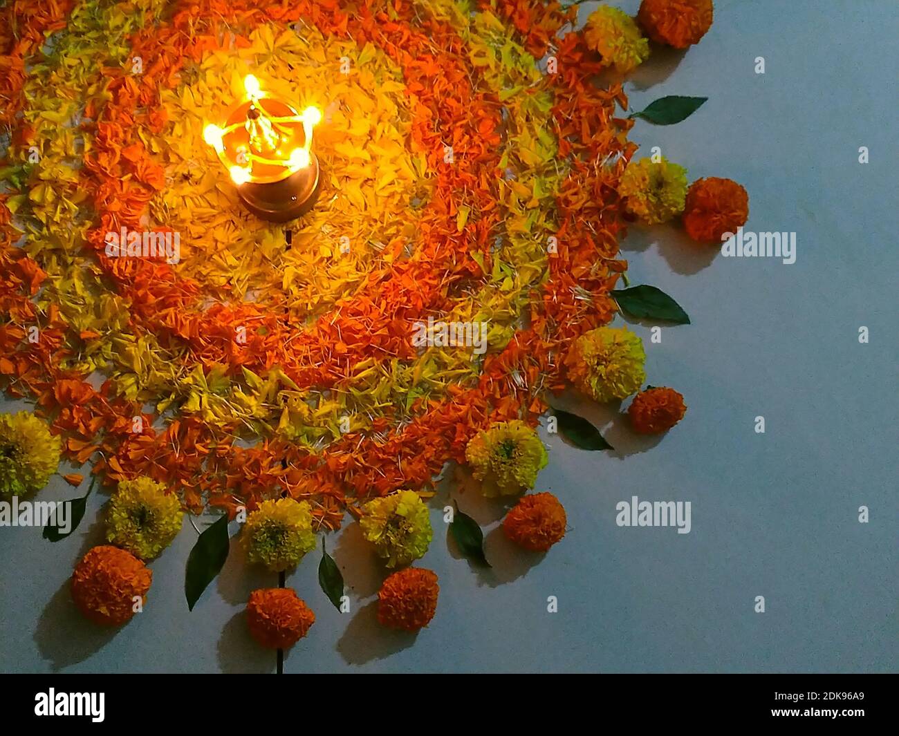 Onam pookalam/floral carpet with lit brass oil lamp--Onam festival ...