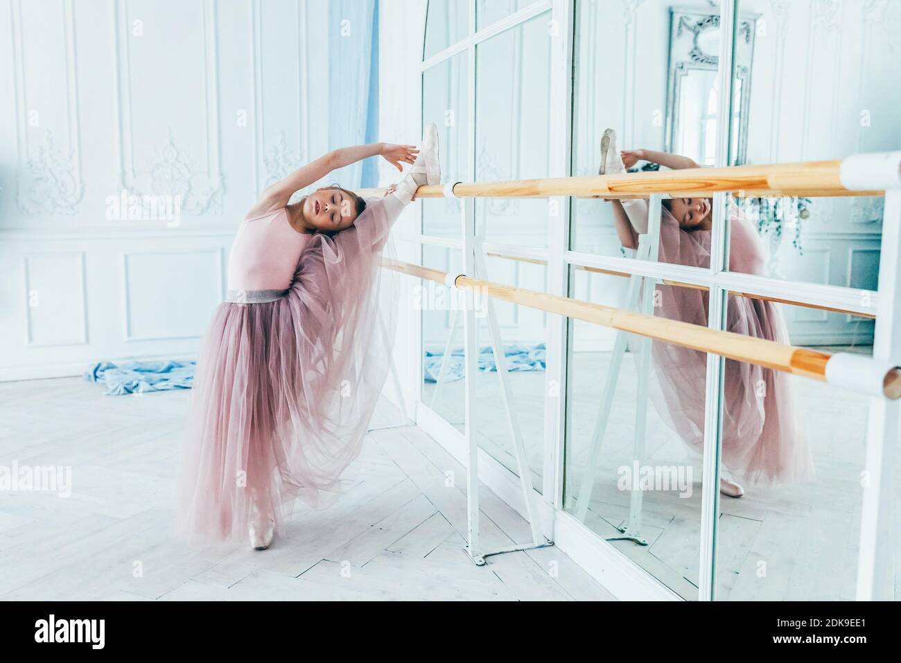 Young classical ballet dancer girl in dance class. Beautiful graceful ...