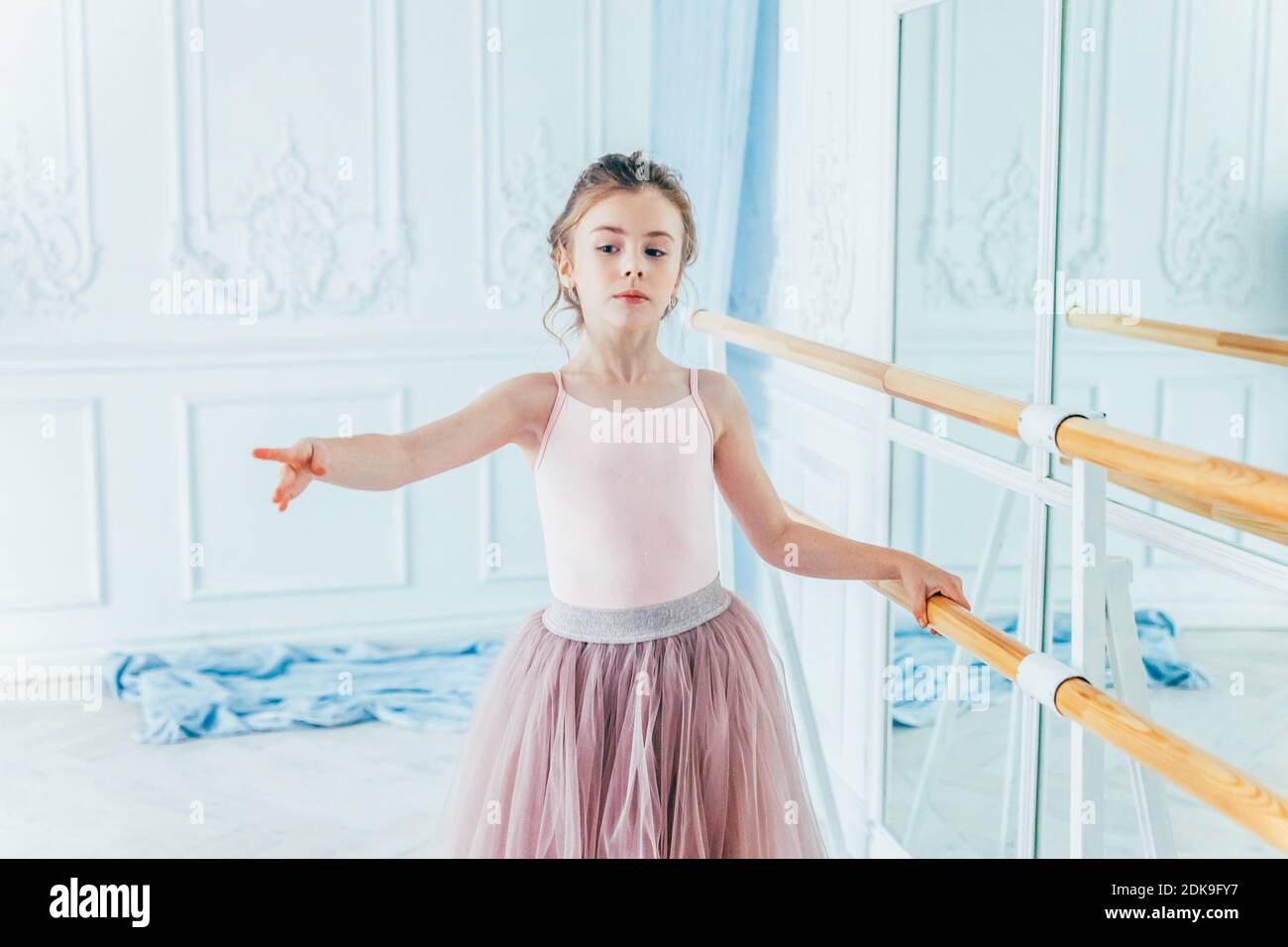 Young classical ballet dancer girl in dance class. Beautiful graceful ...