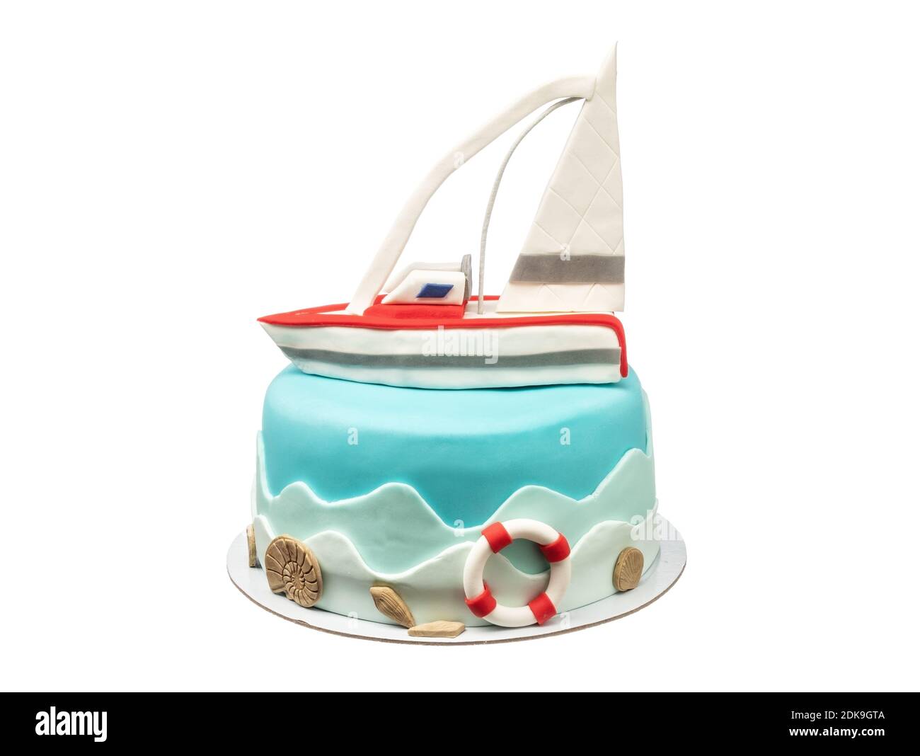 A marine-themed cake, a sugar paste sailboat for a boy's birthday. On a ...