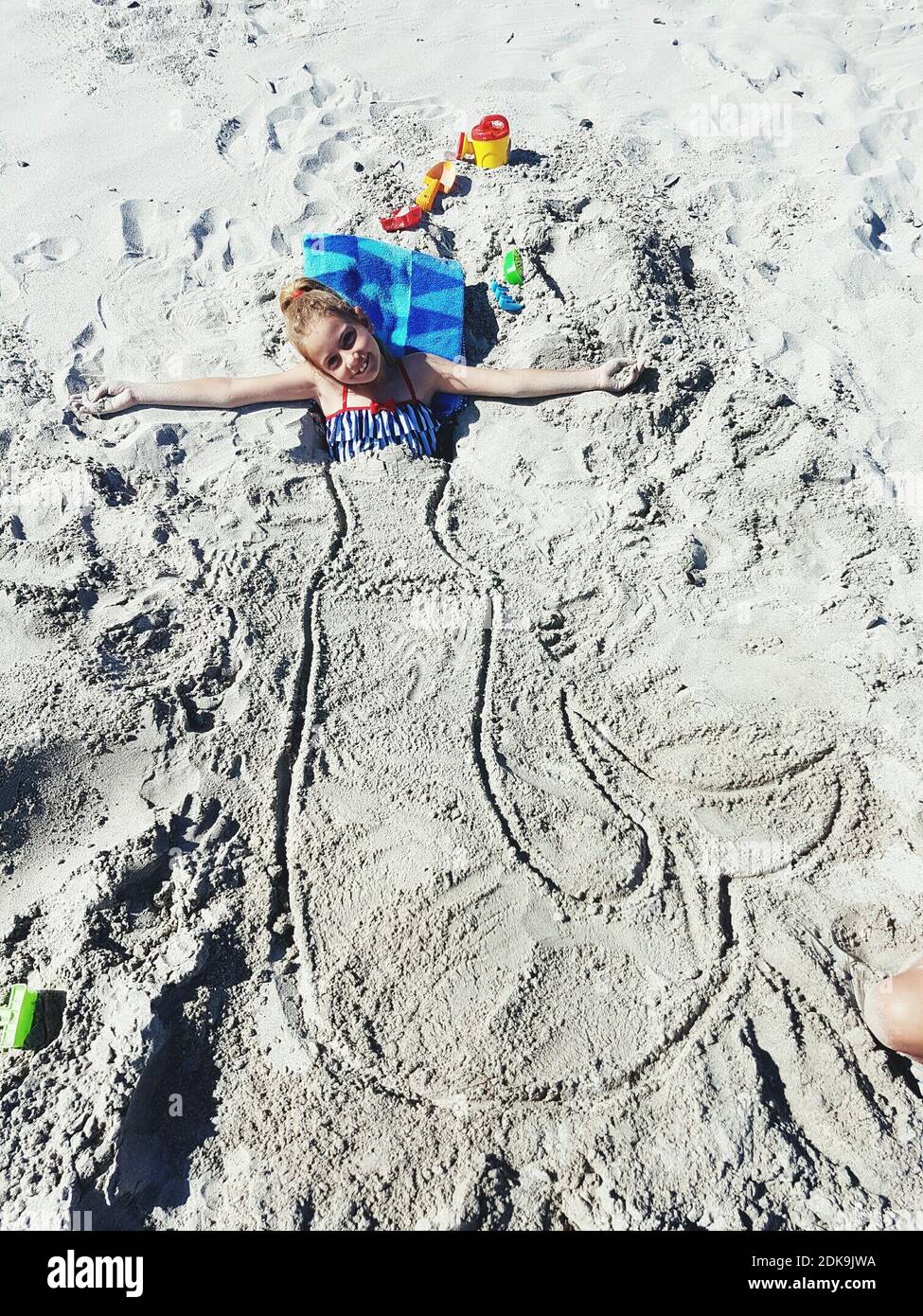 Girl buried in sand hi-res stock photography and images - Alamy
