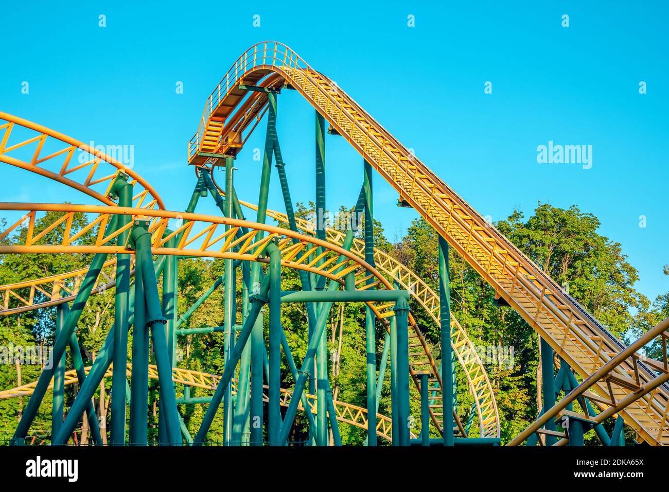 Part view of roller coaster track with blue sky on background at ...