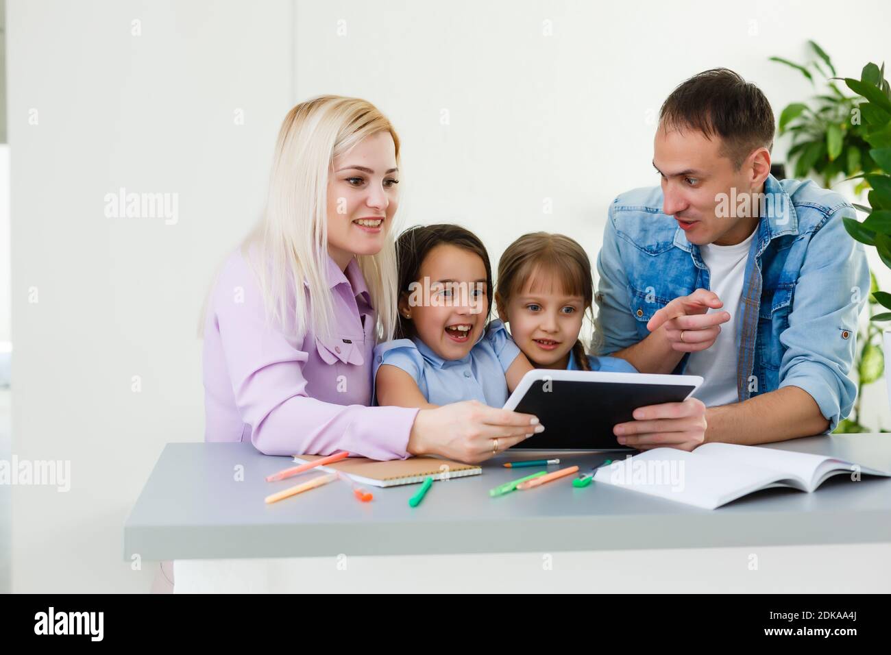 Family With Children Using Technology At Home Stock Photo - Alamy