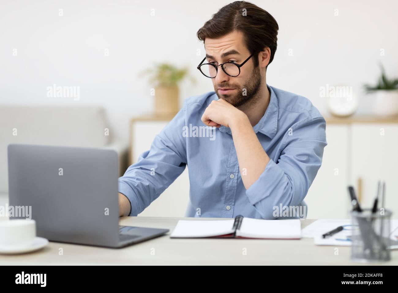Surpirsed Business Guy Looking At Laptop Sitting In Office Stock Photo ...