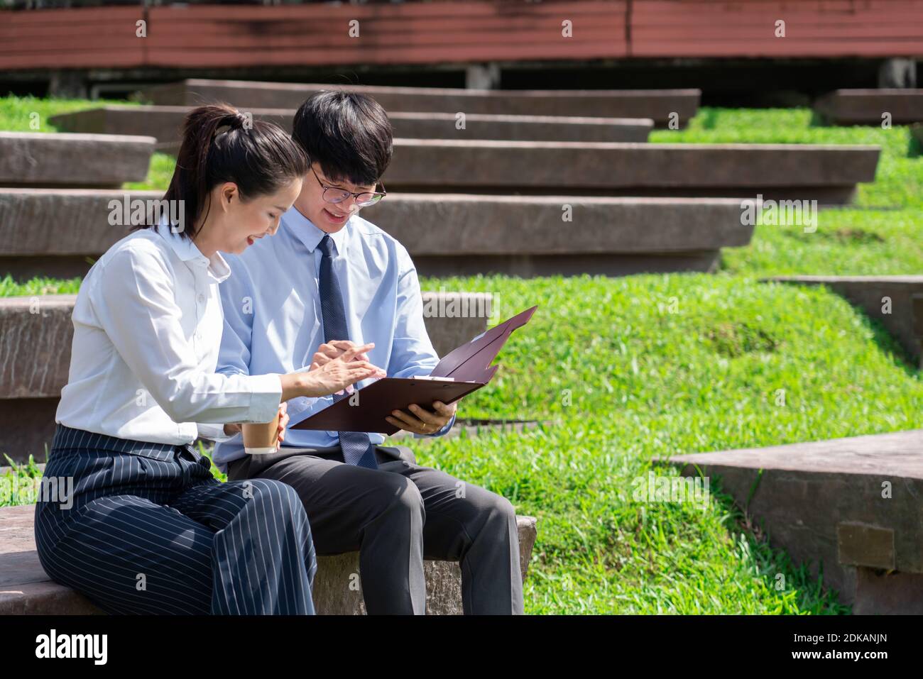 Business colleagues discussing work issues outdoor near the office ...