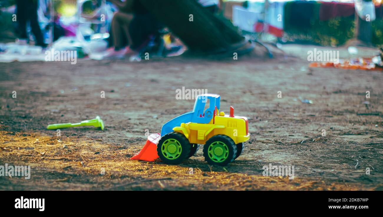 Multi Colored Toy Bulldozer On Land Stock Photo - Alamy