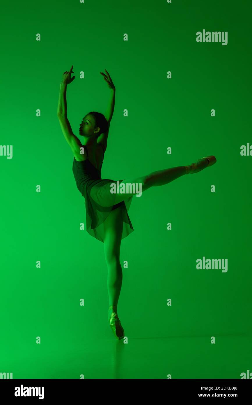Gorgeous. Young and graceful ballet dancer isolated on gradient green ...