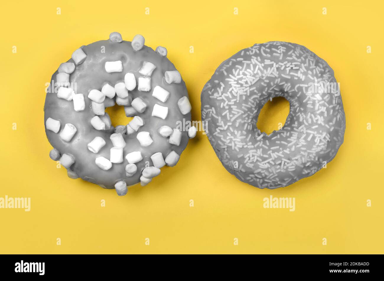 Colors of year 2021. Gray and Yellow. Two donuts with icing on bright ...