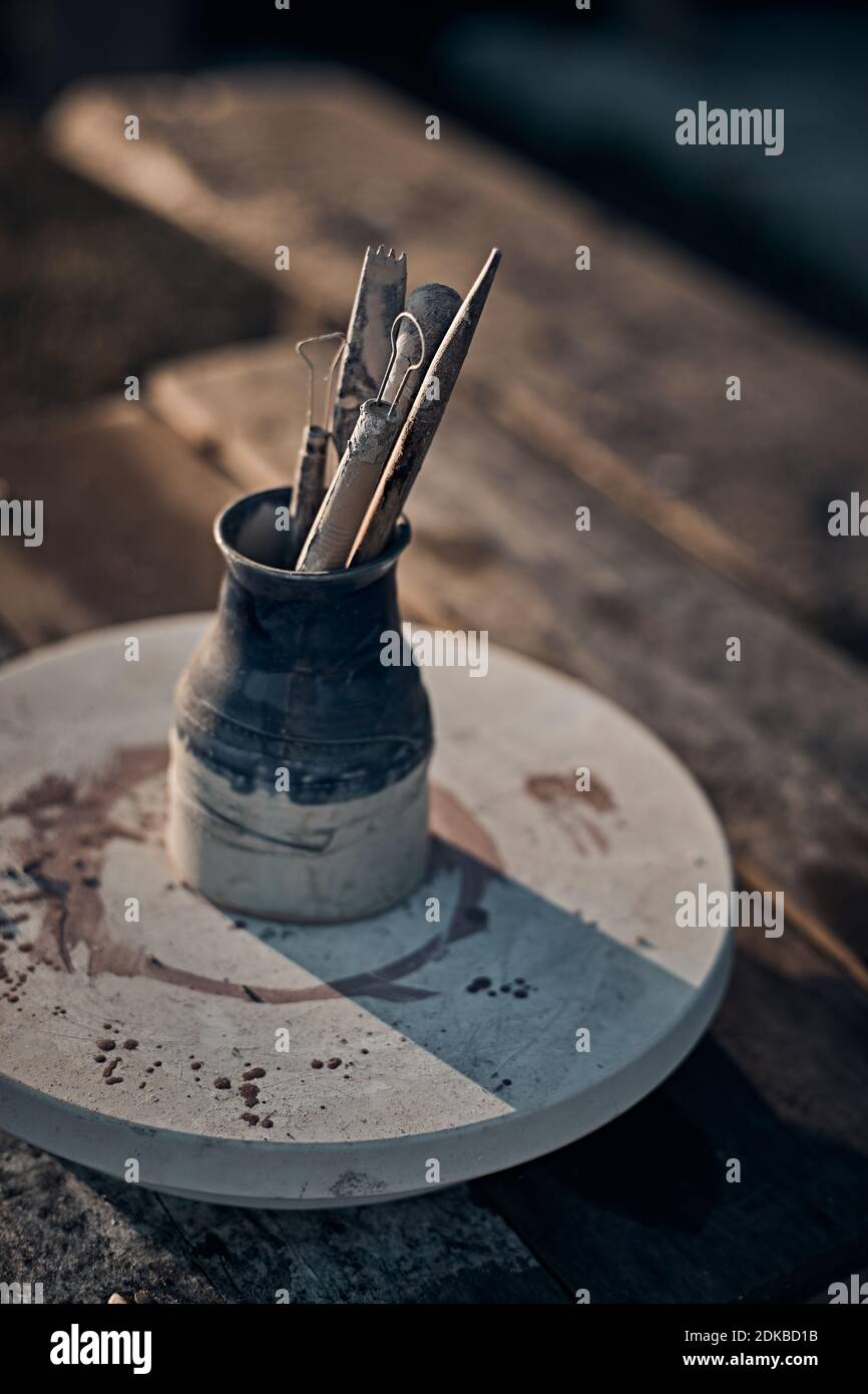 Tools for forming clay on wooden background Stock Photo - Alamy