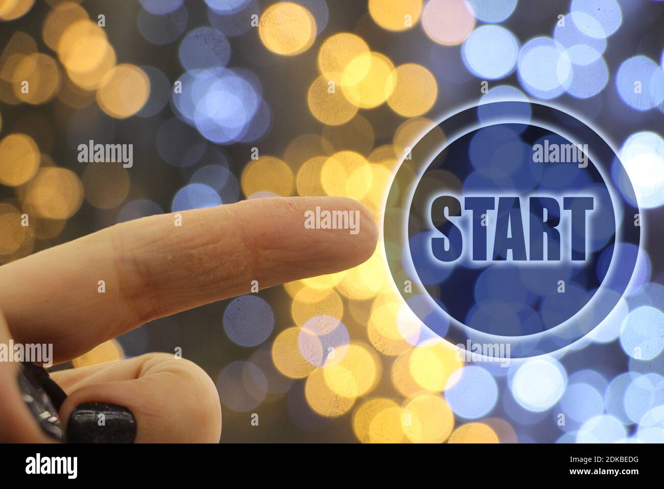 Woman hand push start button on touch screen over blue and golden bokeh ...