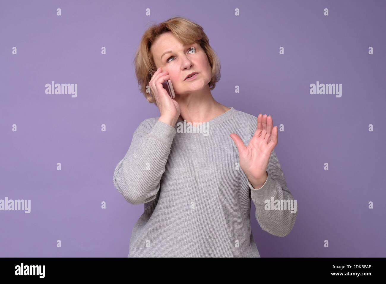 Senior woman talking on phone with client support trying to explain her ...