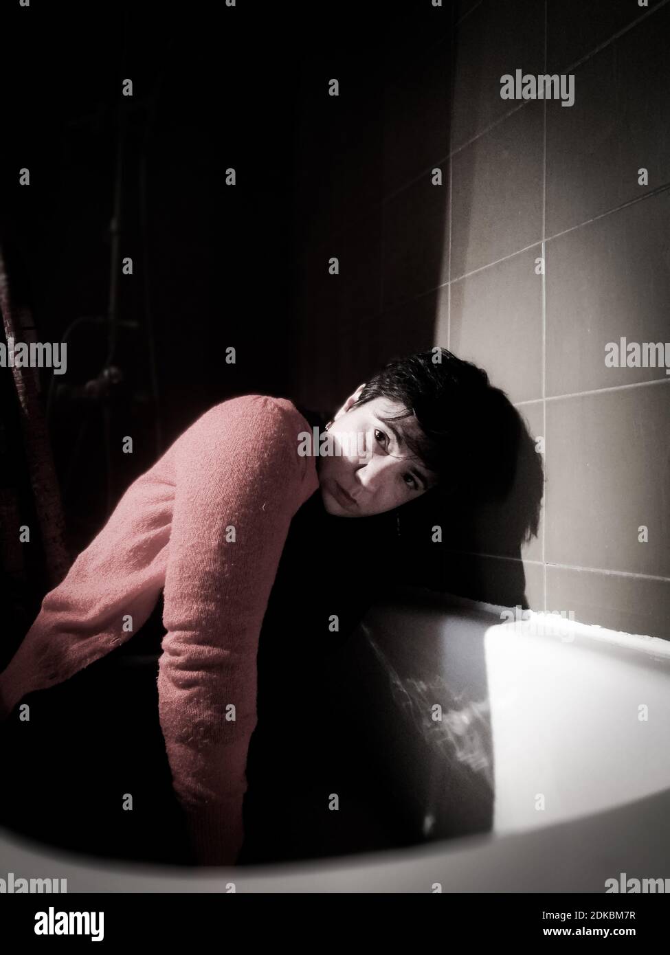 Woman sitting in bathroom sad hi-res stock photography and images - Alamy