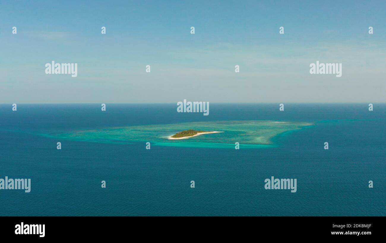 Tropical island Canimeran with sandy beach in the blue sea with coral ...