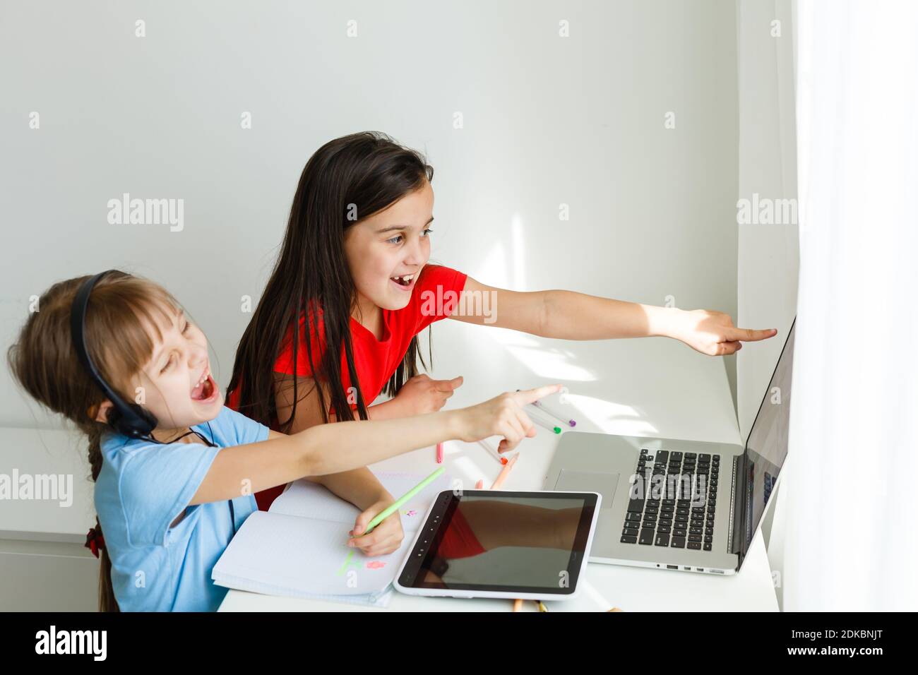 Cool online school. Kids studying online at home using a laptop ...
