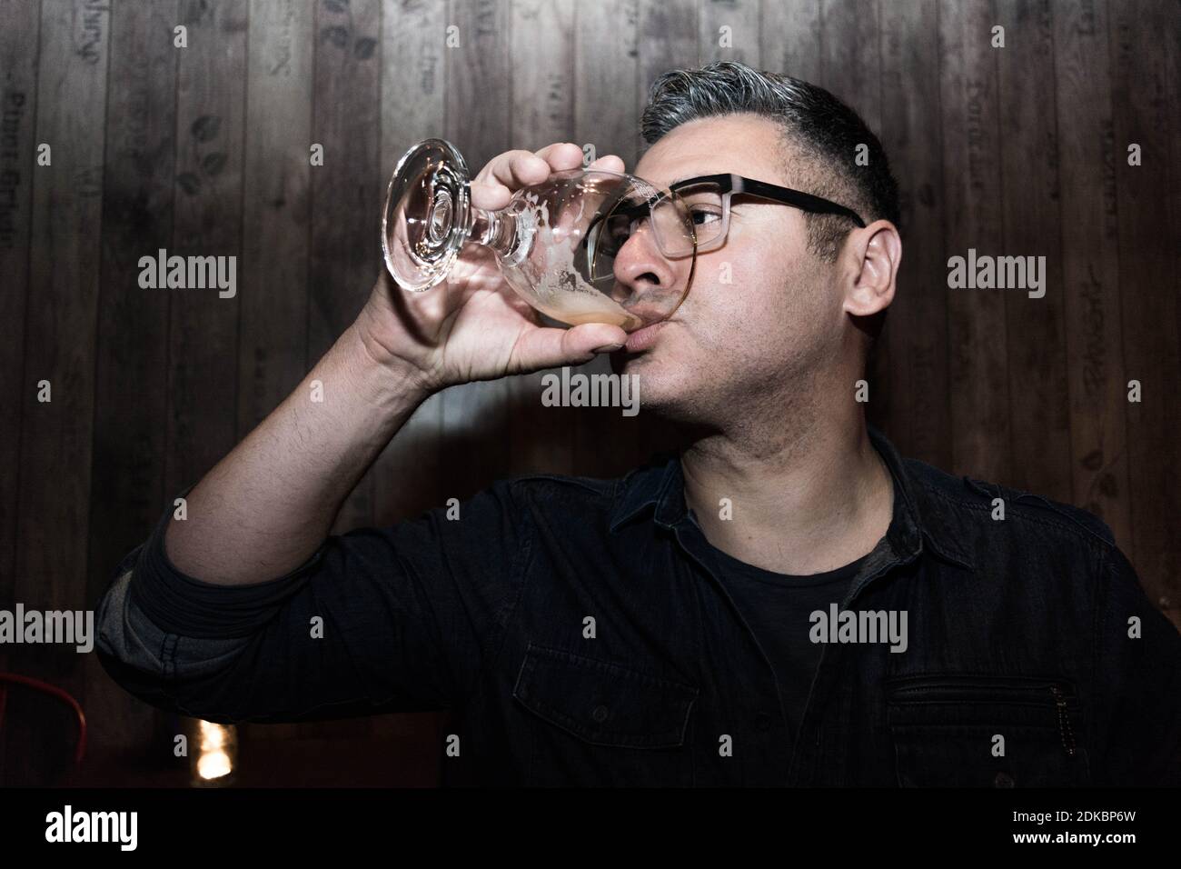 Man Drinking Drink Against Wall Stock Photo - Alamy