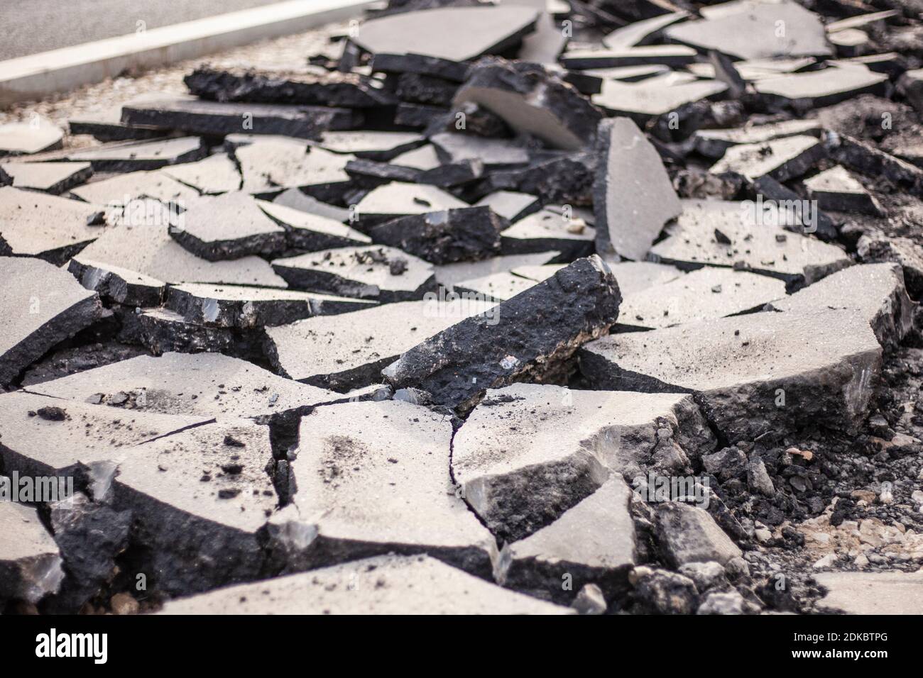 Broken asphalt. Repair pavement in the city. Highway after heavy ...