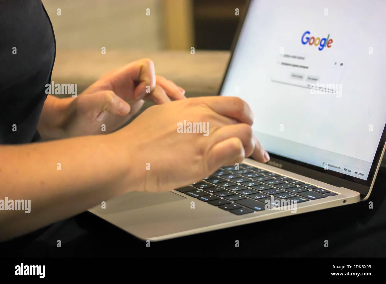Girl looking for information on Google search engine, typing on laptop ...